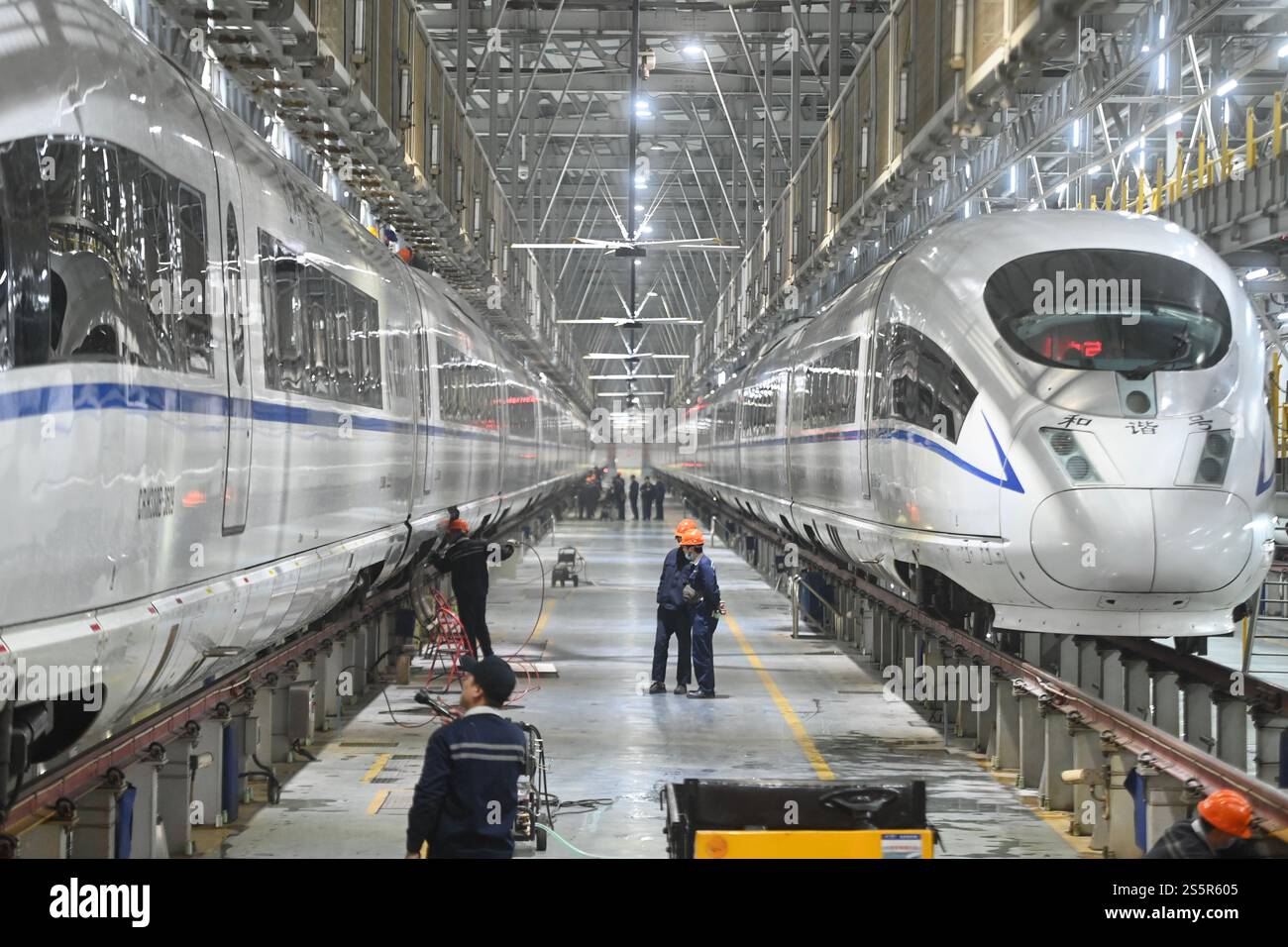 Hefei,China.13th January 2025. Maintenance workers check bullet trains ...