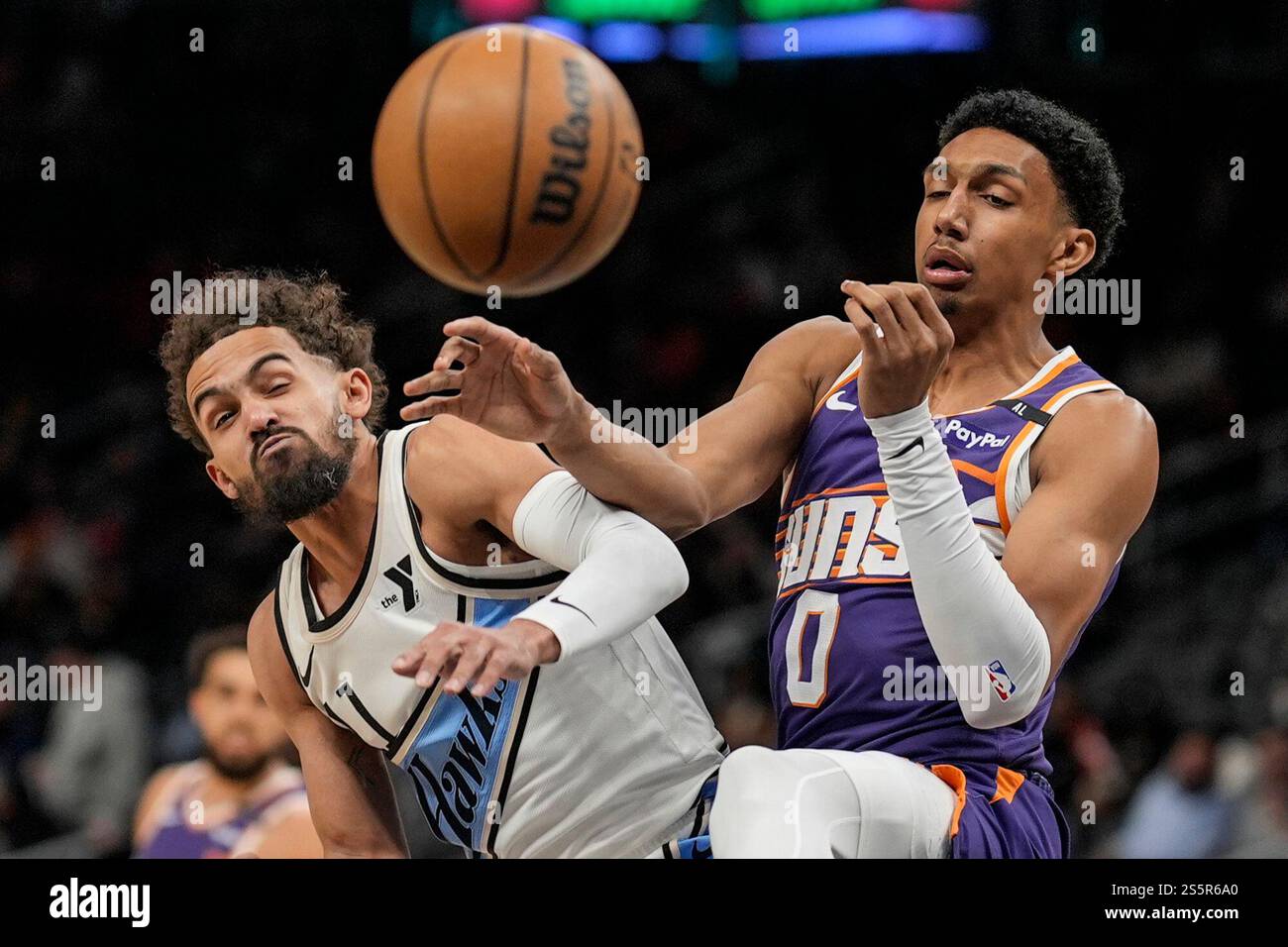 Phoenix Suns forward Ryan Dunn (0) collides with Atlanta Hawks guard ...