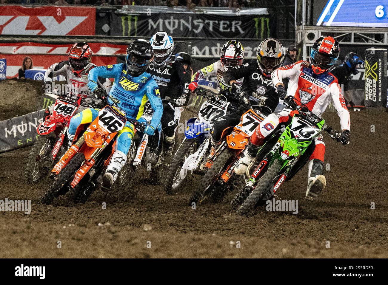 Riders from the 450 group B class rounding the hole shot corner for a ...