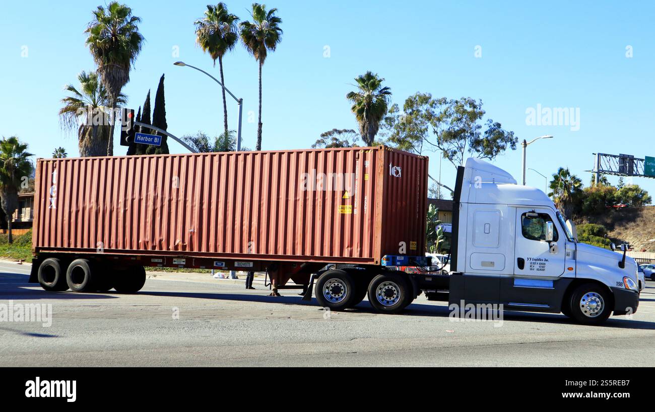 Freight Truck carrying a TEX shipping container on a street toward the ...