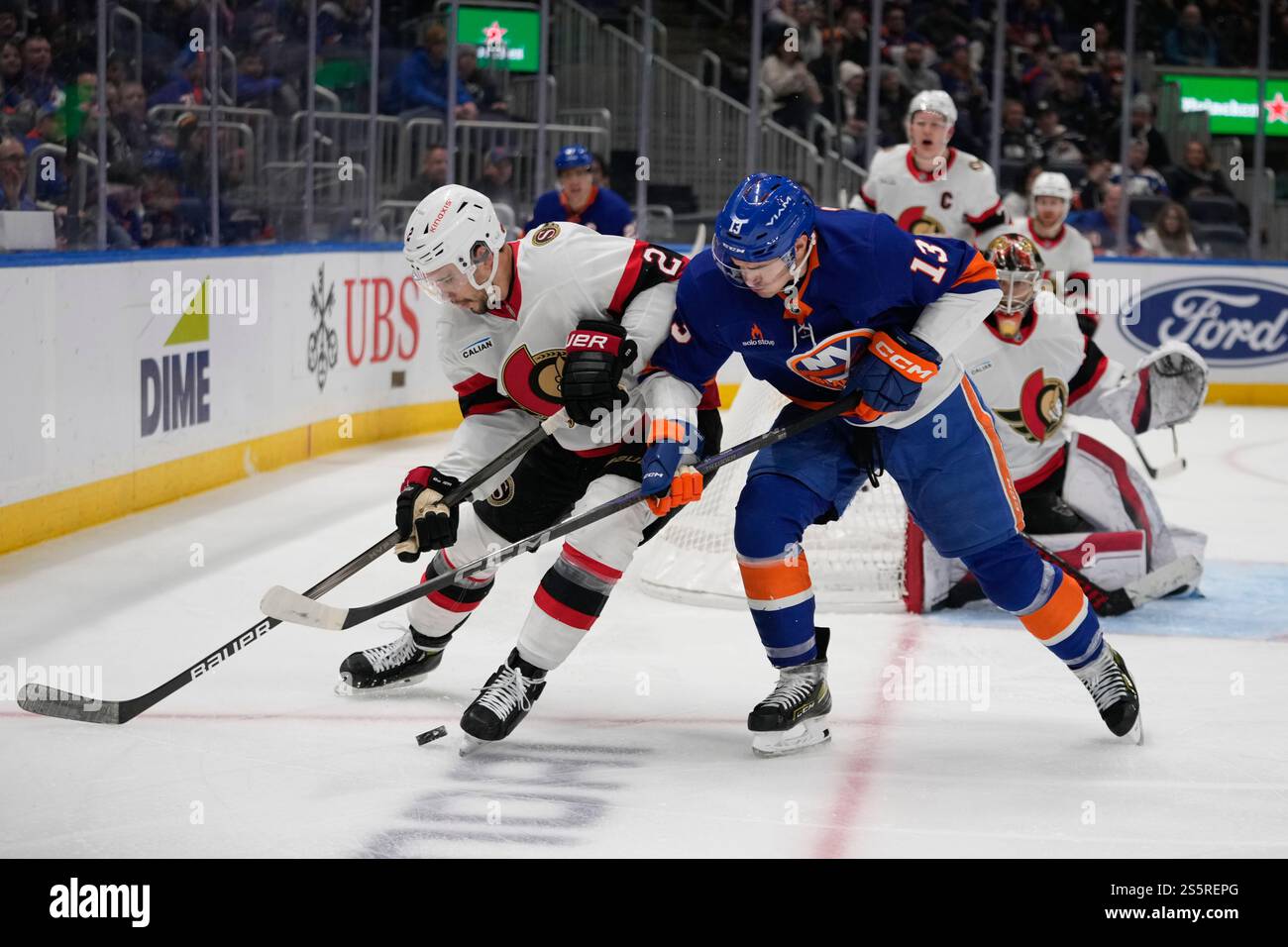 New York Islanders' Mathew Barzal (13) fights for control of the puck ...