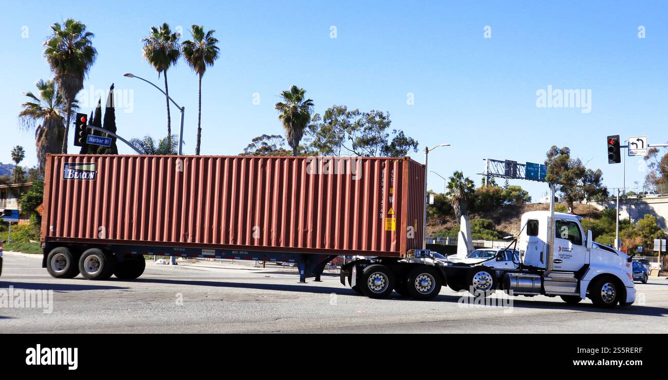 Freight Truck carrying a BEACON shipping container on a street toward ...