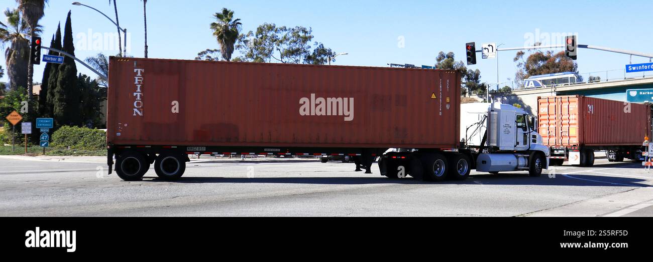 Freight Truck carrying a TRITON shipping container on a street toward ...
