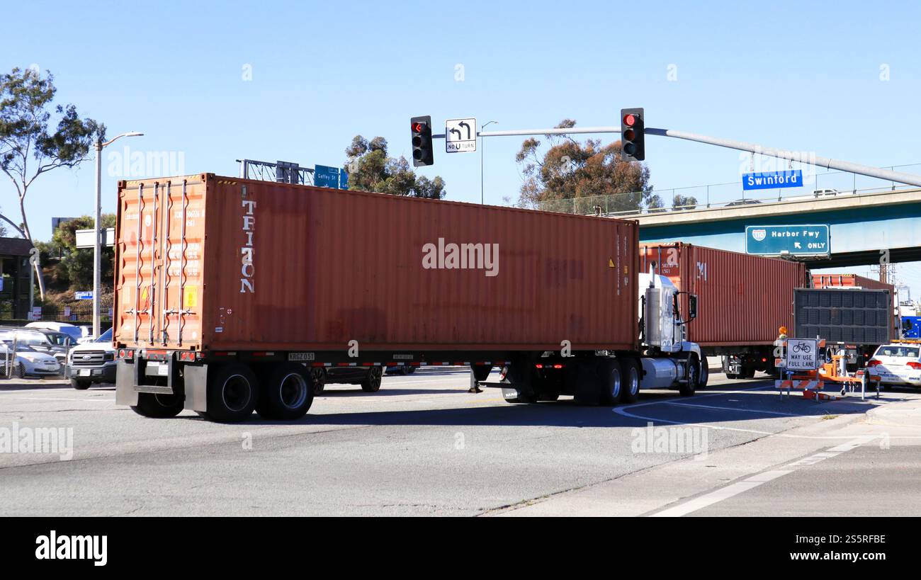 Freight Truck carrying a TRITON shipping container on a street toward ...