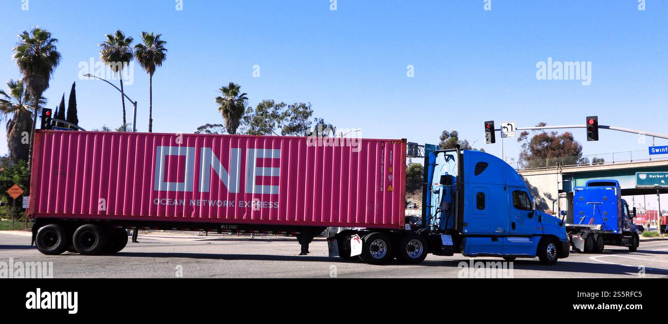 Freight Truck carrying an ONE Ocean Network Express shipping container on a street toward the ...