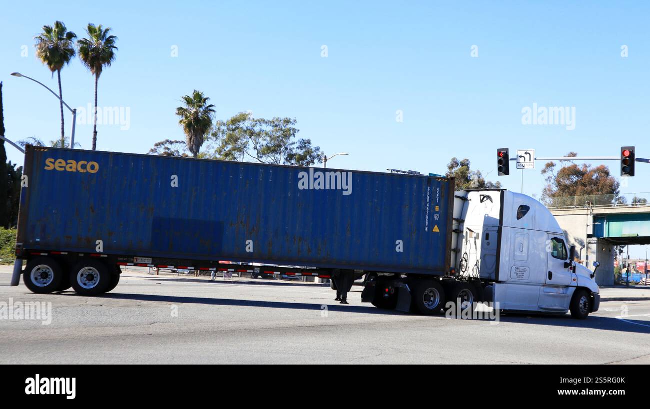 Freight Truck carrying a SEACO shipping container on a street toward ...