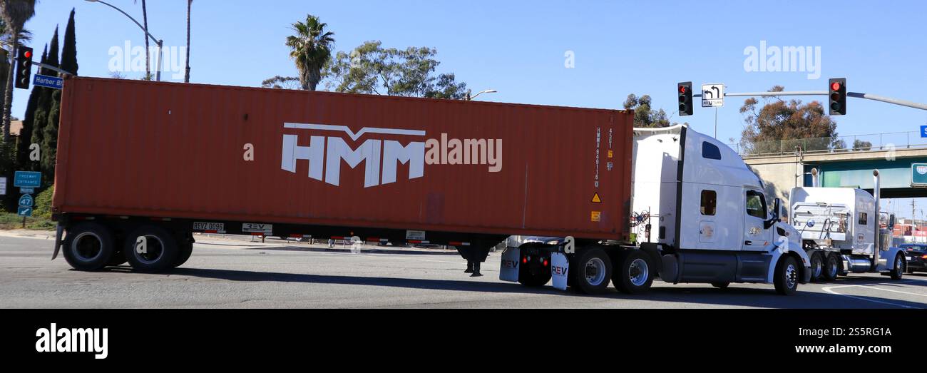 Freight Truck carrying a HMM shipping container on a street toward the ...