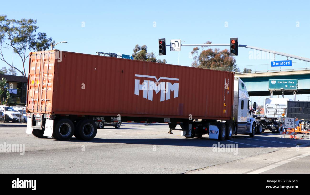 Freight Truck carrying a HMM shipping container on a street toward the ...