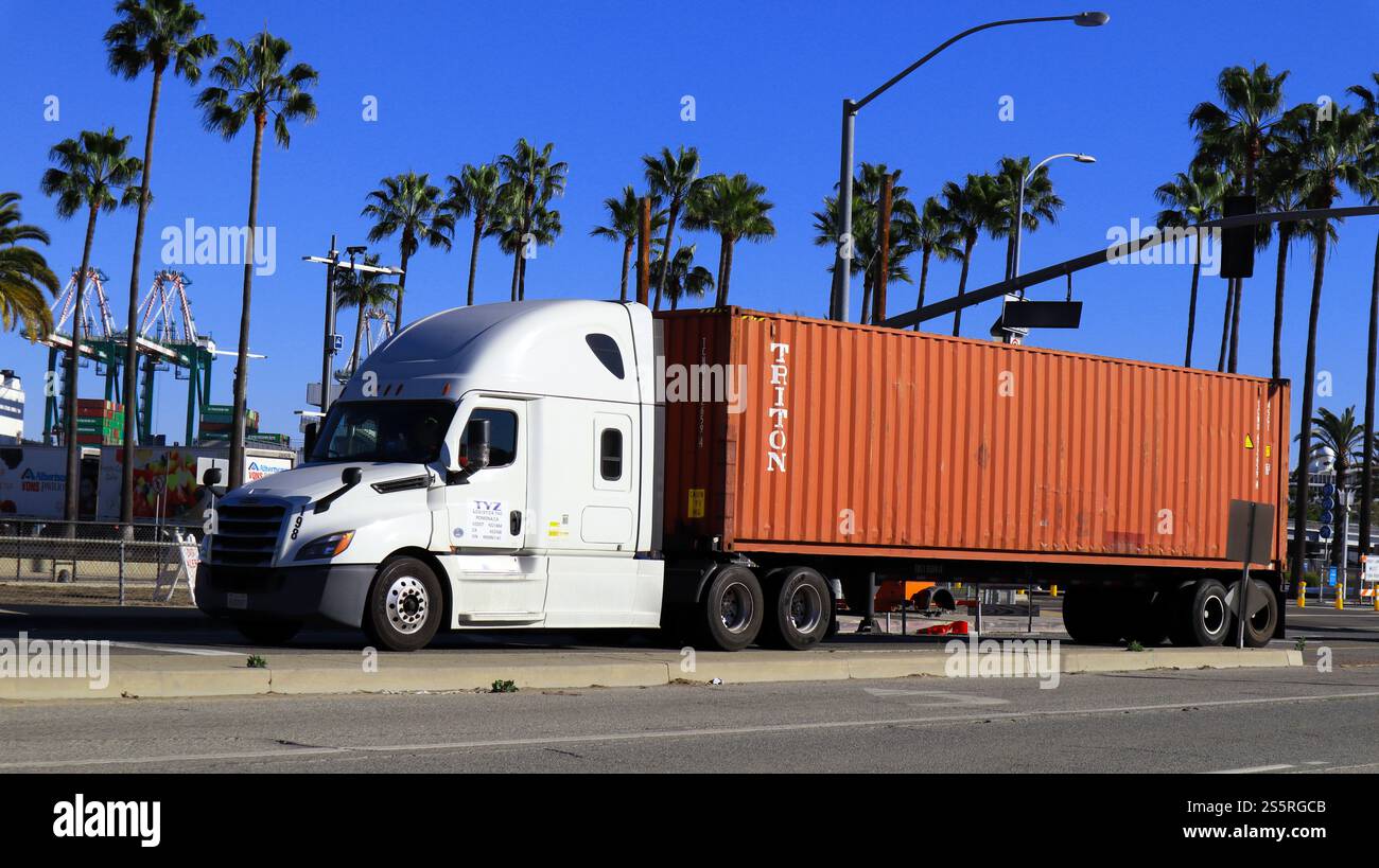 Freight Truck carrying a TRITON shipping container on a street toward ...
