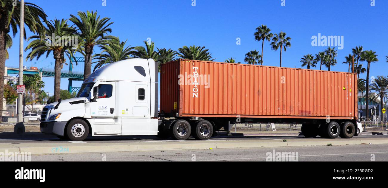 Freight Truck carrying a TRITON shipping container on a street toward ...