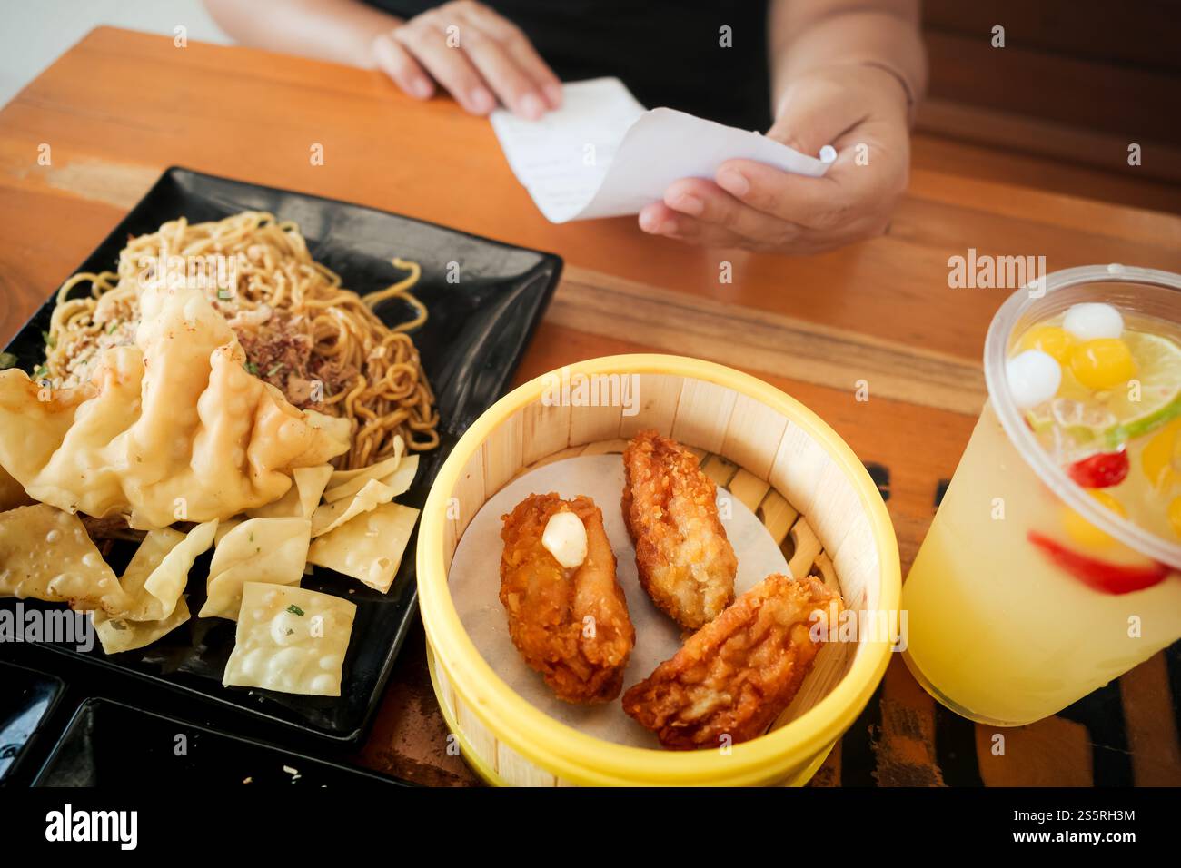 Person checking restaurant bill before eating served meals Stock Photo ...
