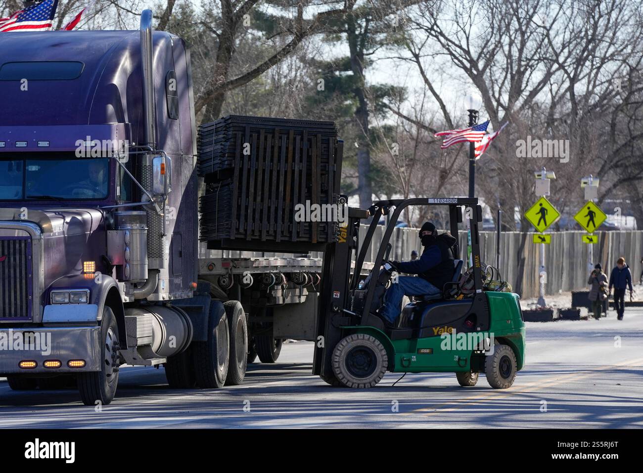 Workers unload security fencing on 17th Street next to the Ellipse near ...