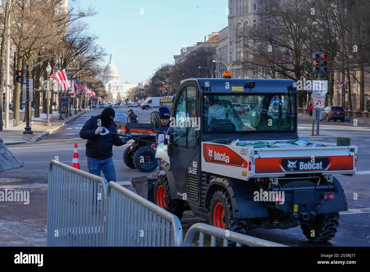 Workers clear snow along Pennsylvania Avenue near Freedom Plaza ahead ...