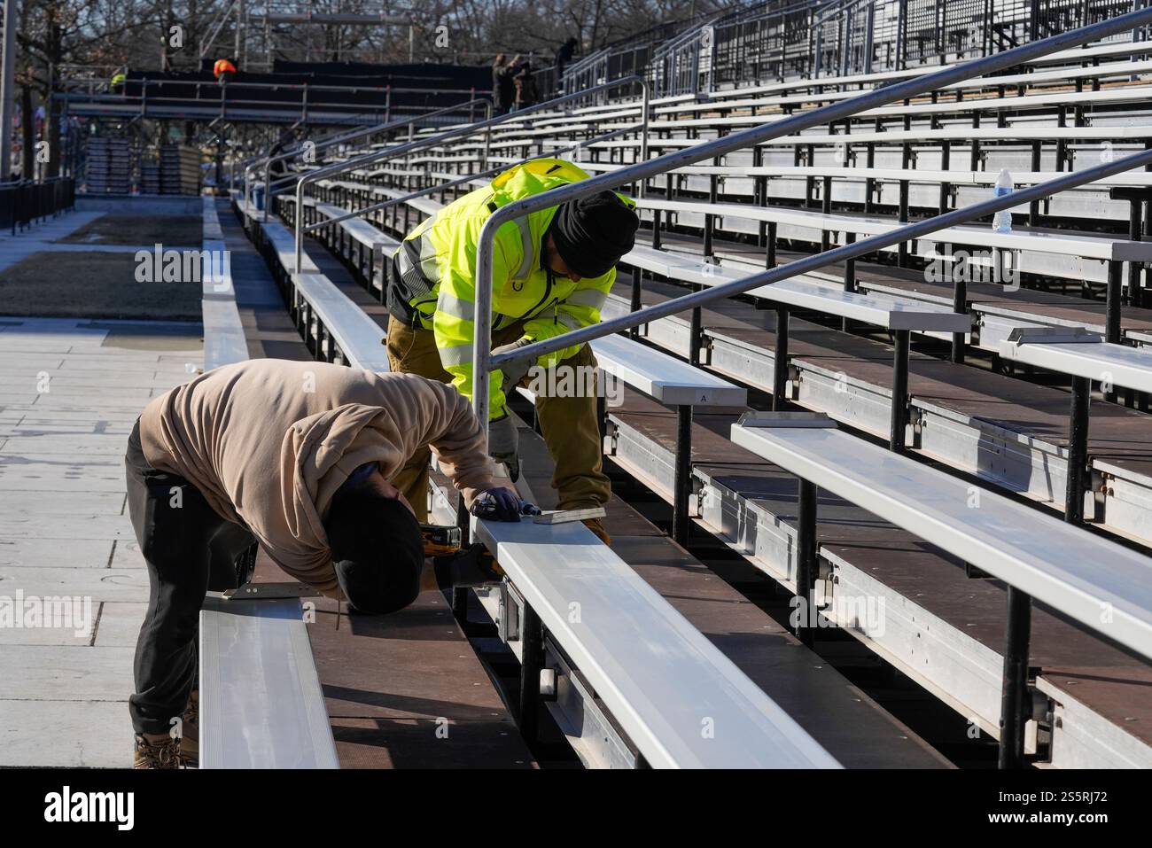 Workers construct bleachers at Freedom Plaza along Pennsylvania Avenue ...