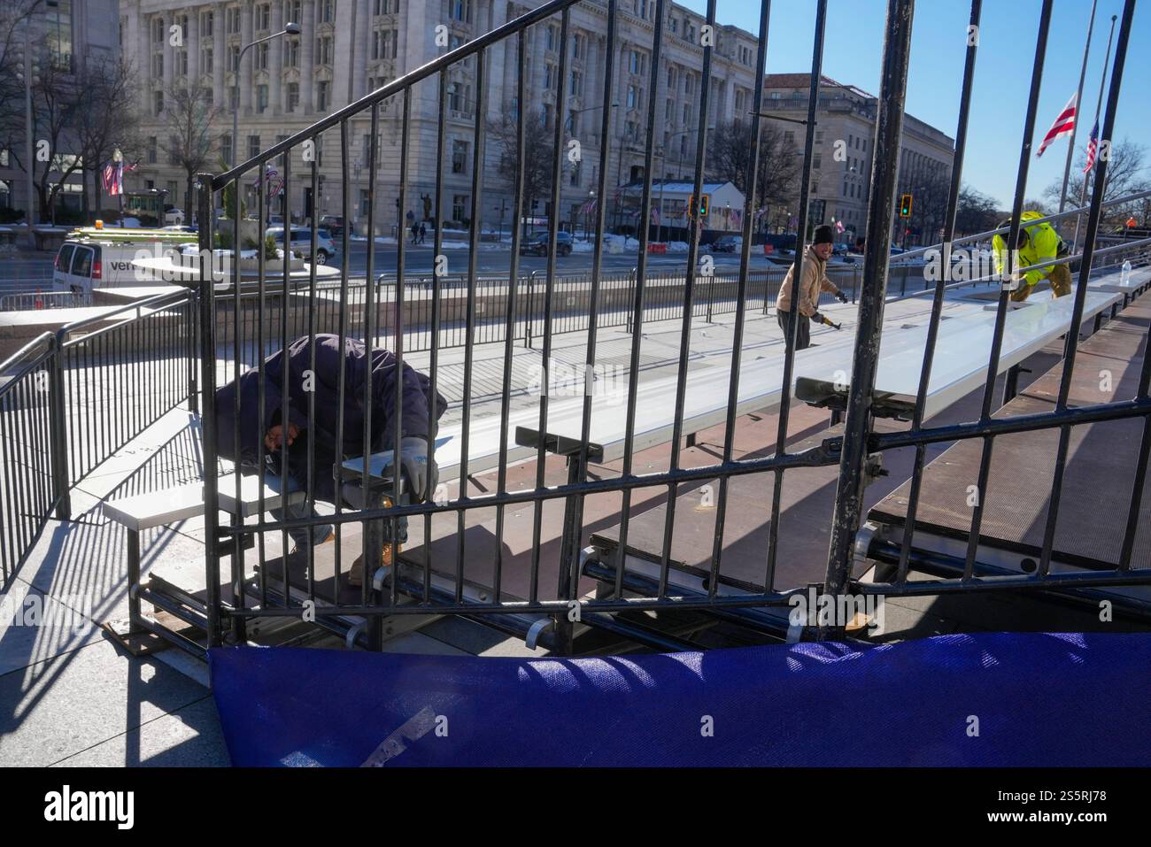 Workers build bleachers at Freedom Plaza along Pennsylvania Avenue for ...