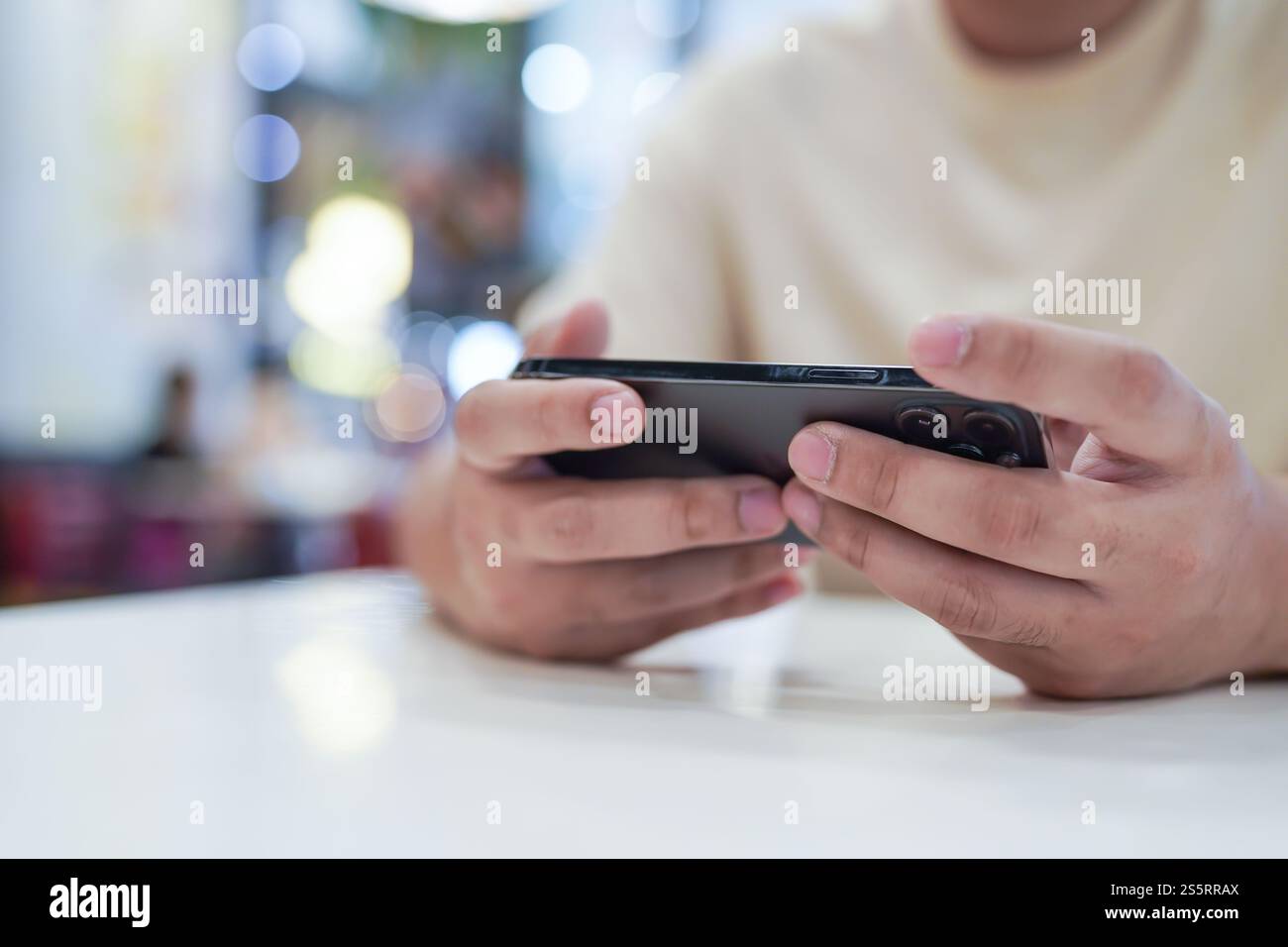Man playing game on mobile phone. gamer boy playing video games holding ...