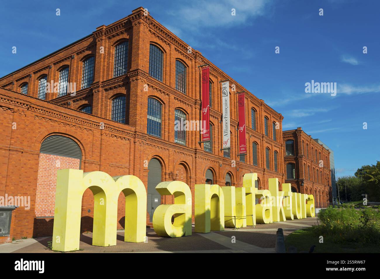 Historic building with yellow signage, blue sky. Popular cultural ...