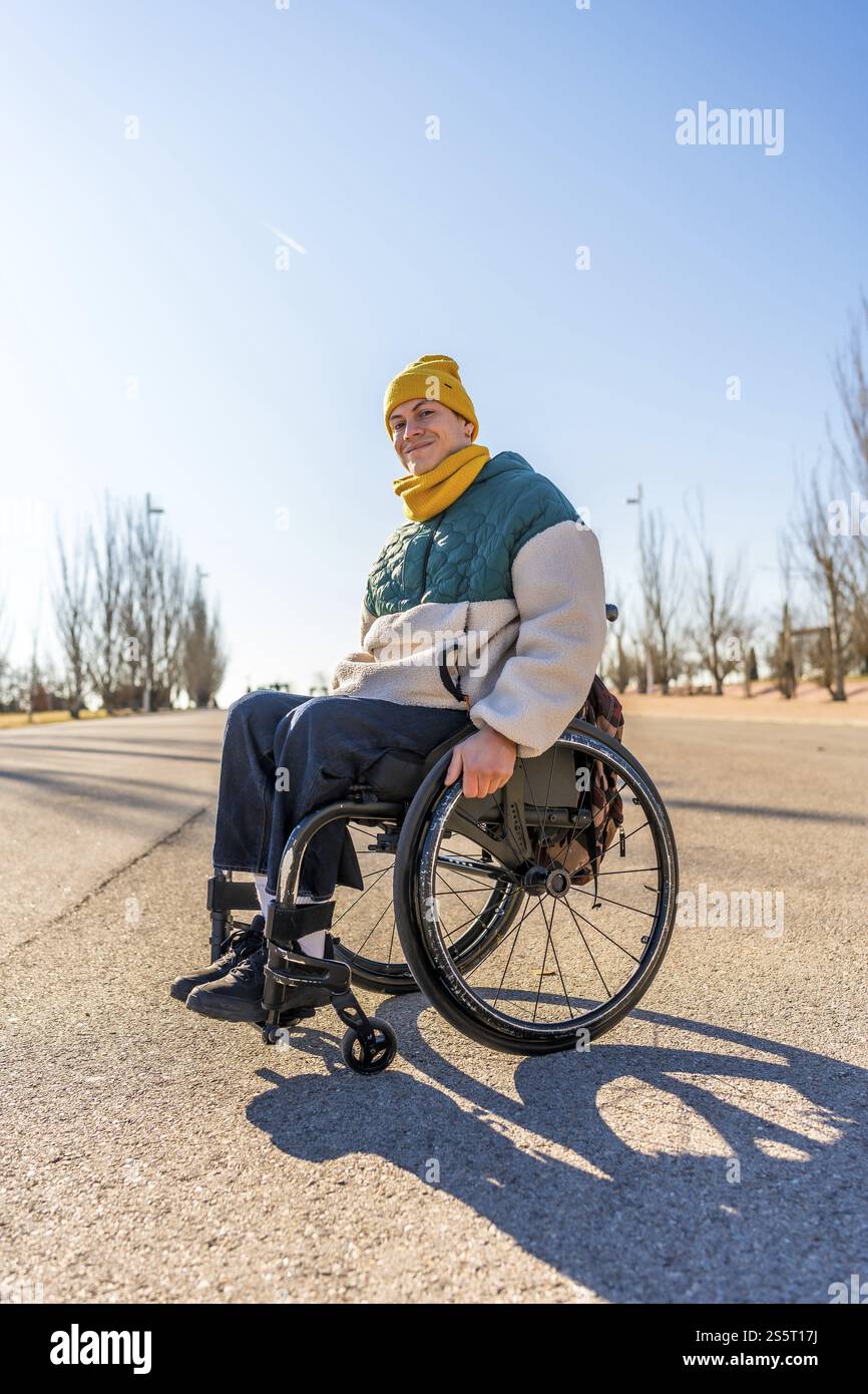 Young person with disability enjoying a sunny day in a wheelchair ...