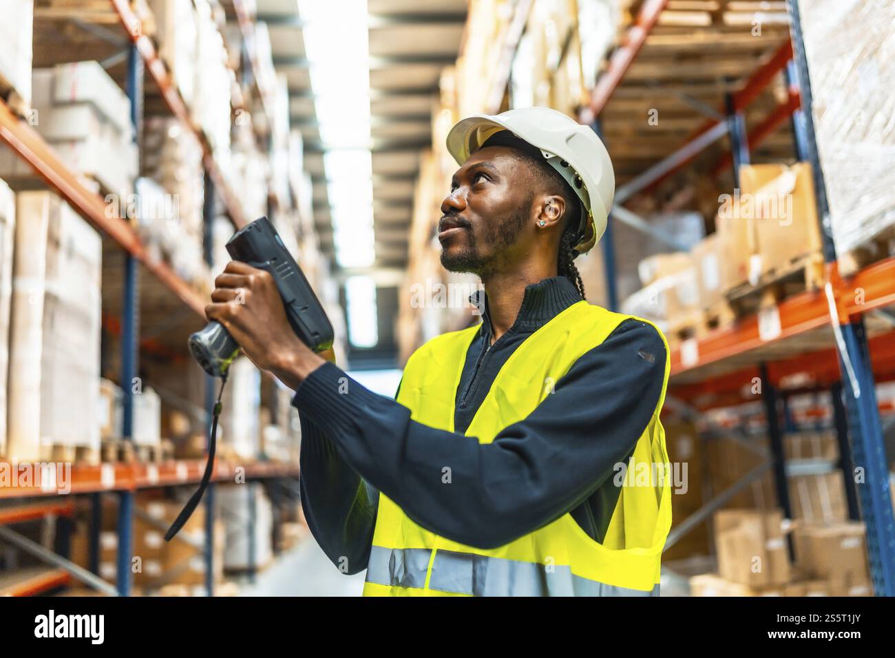 African man using a wireless scan to do inventory in a warehouse Stock ...