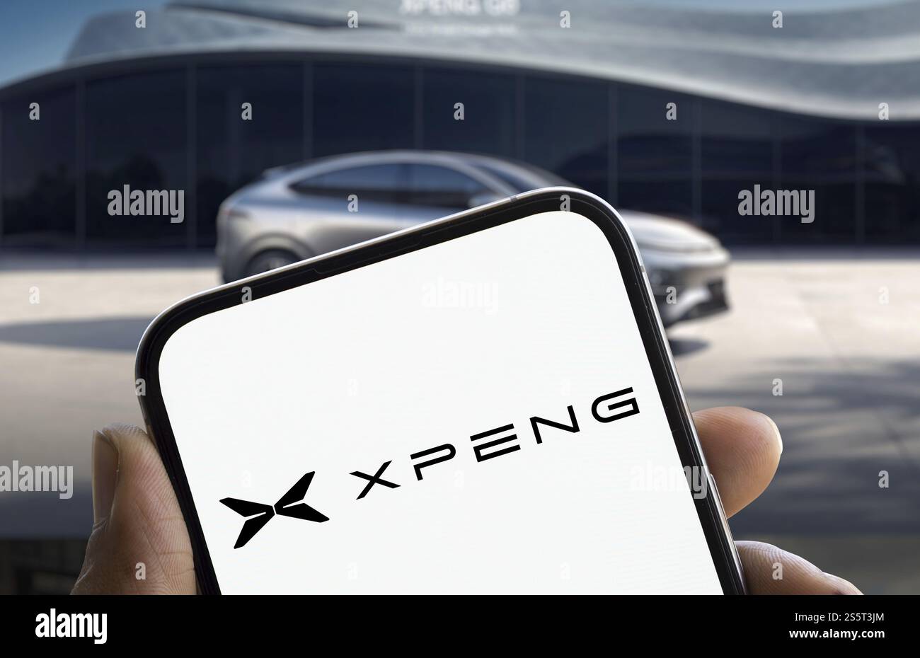 Xpeng logo is displayed on smartphone. Guangzhou Xiaopeng Motors ...
