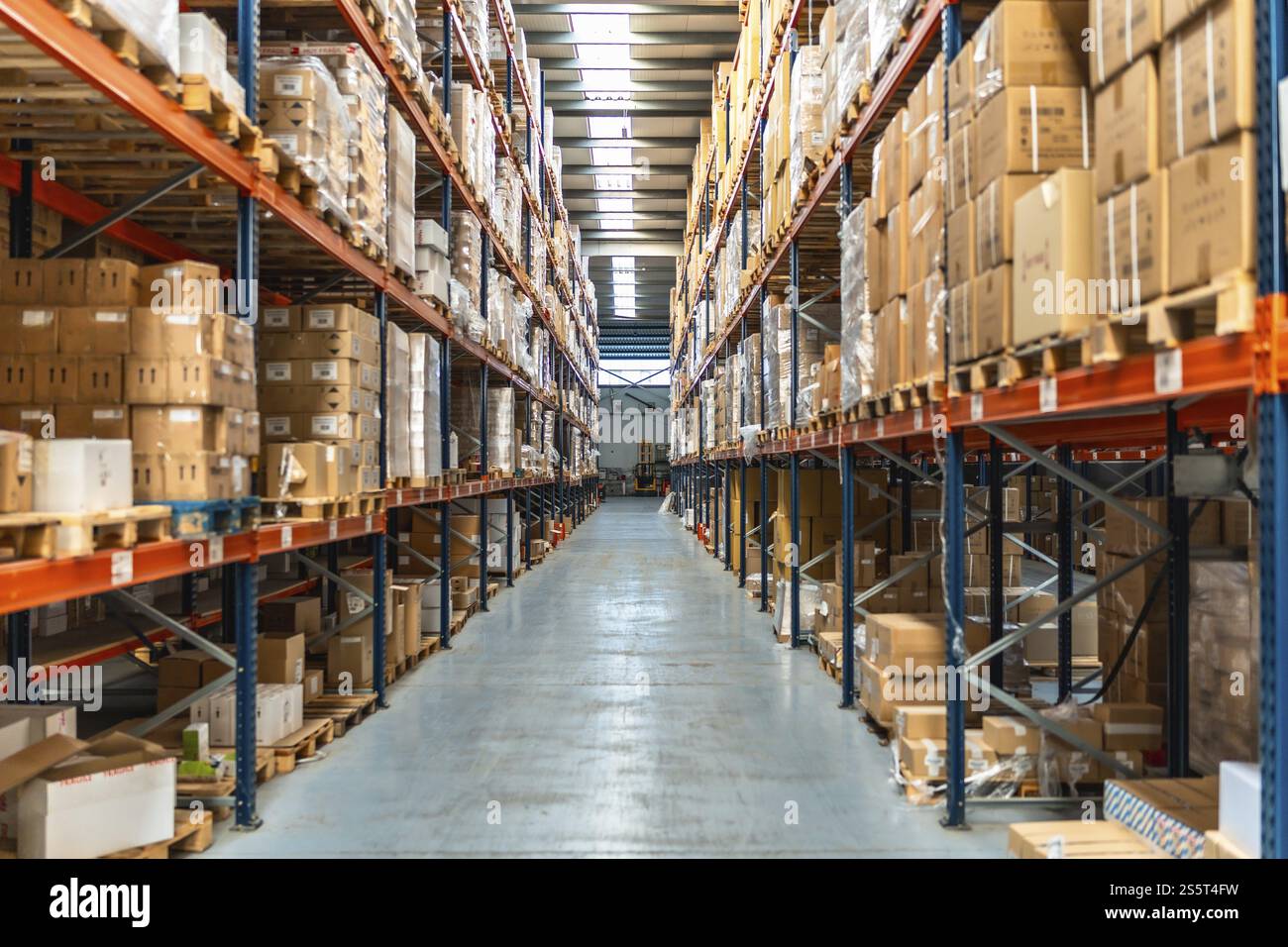 Interior view of an aisle of a distribution warehouse full of packages ...