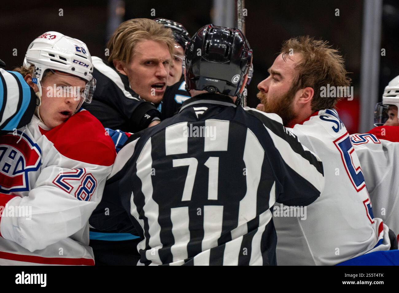 Linesman Brad Kovachik (71) breaks up a scuffle between Montreal ...
