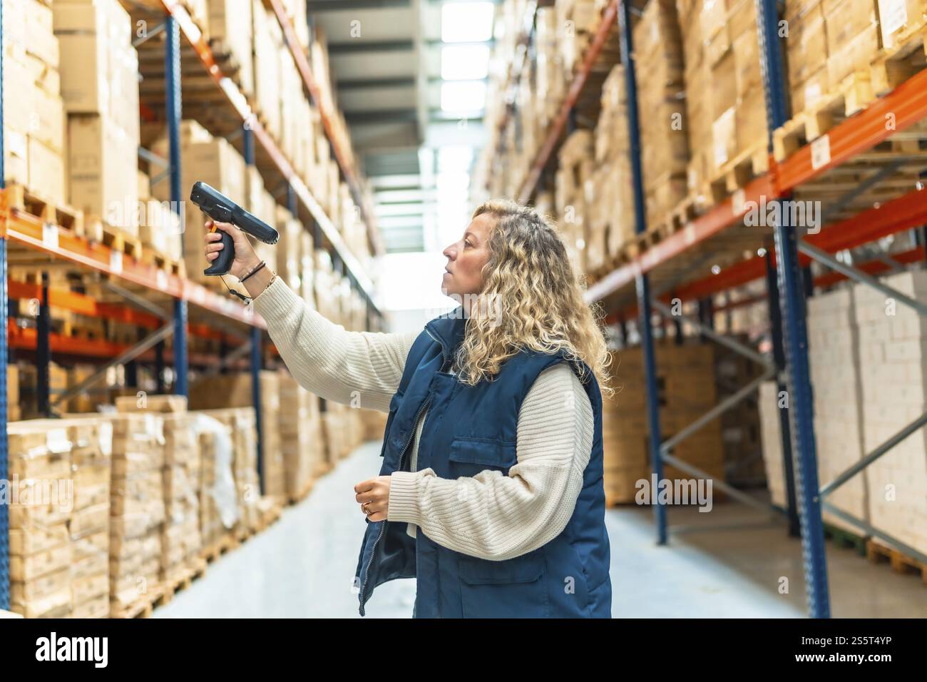 Side view of a blonde caucasian adult woman tracking packages using ...