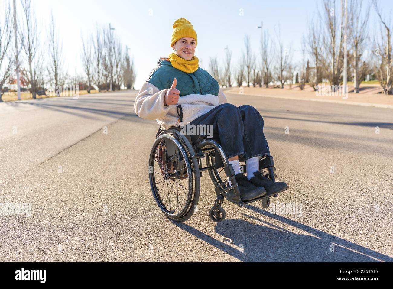 Happy young person with disability enjoying a sunny day in a wheelchair ...
