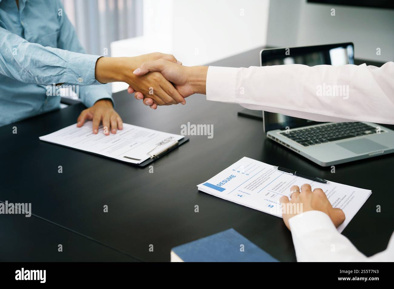 Businessman shaking hands successful candidate at interview. got the ...