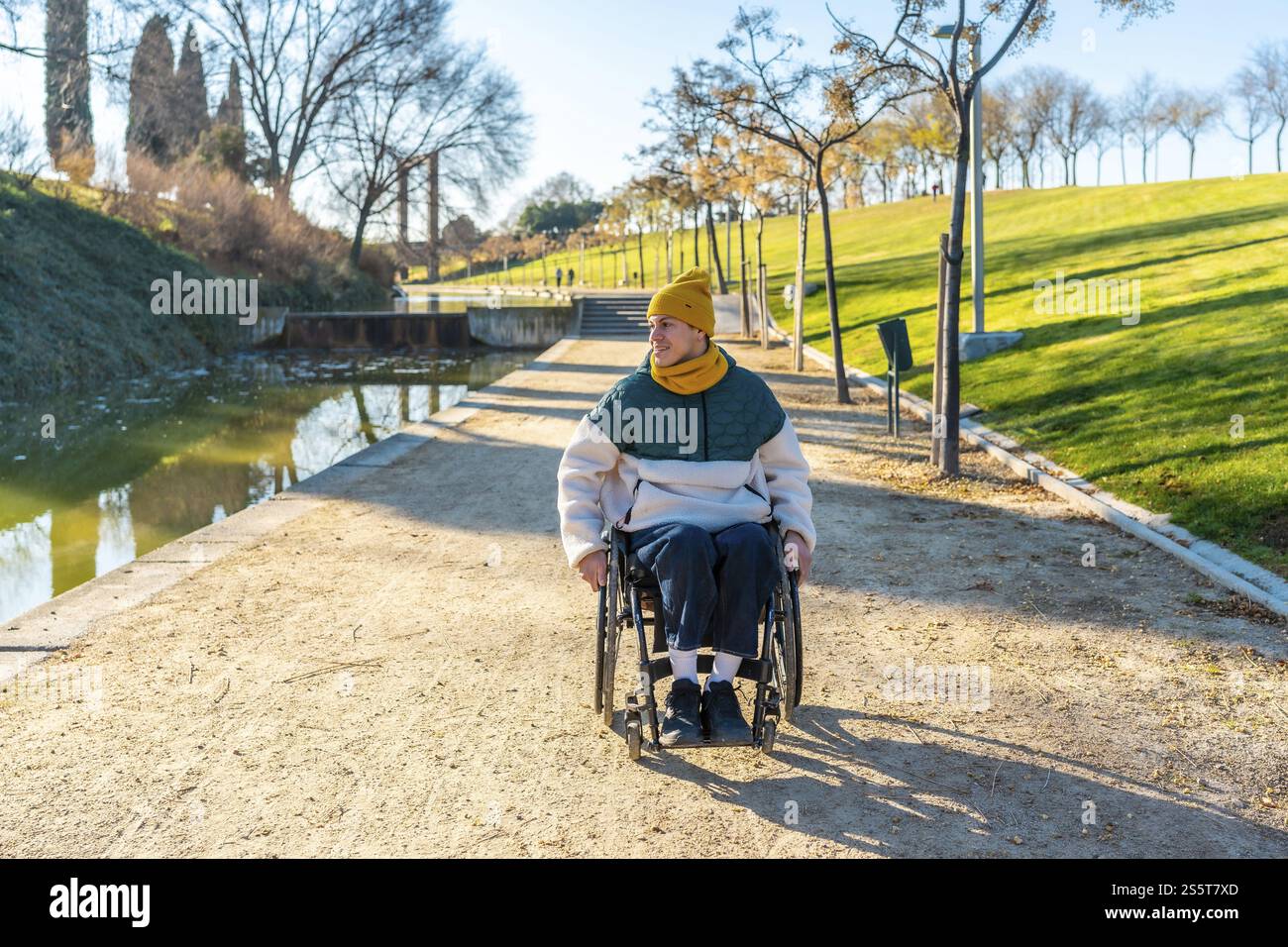 Young man with disability enjoying a walk in a park on a sunny day ...