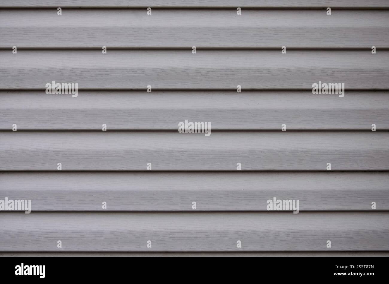 Siding, plastic panels texture closeup in the daytime outdoors. Plastic ...