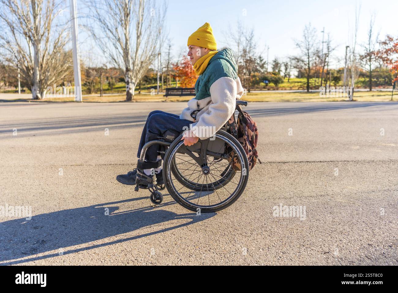 Person with a disability enjoying a sunny day in the park while using a ...