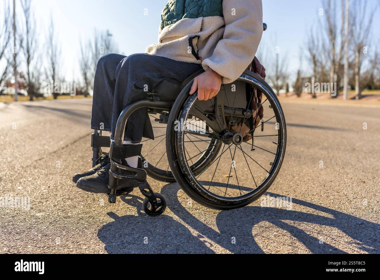 Person using wheelchair enjoying a sunny day in a park, promoting ...