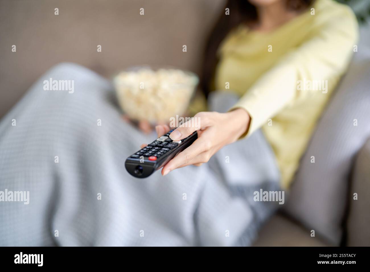 Asian woman Watching smart TV and using remote controller Hand holding ...