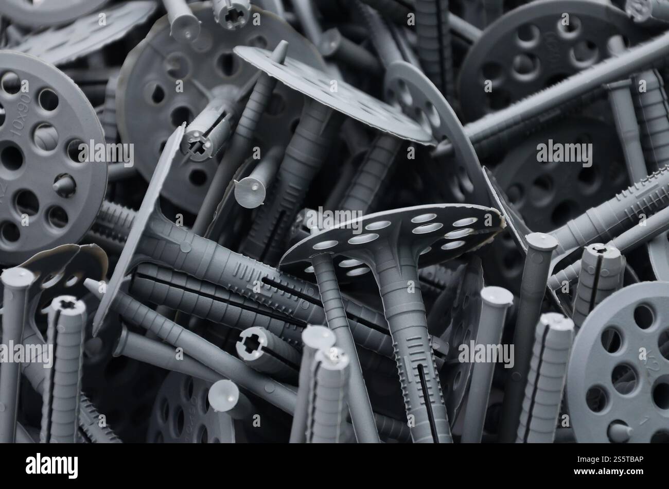 Background pattern of many gray plastic dowels (fastening) for thermal ...