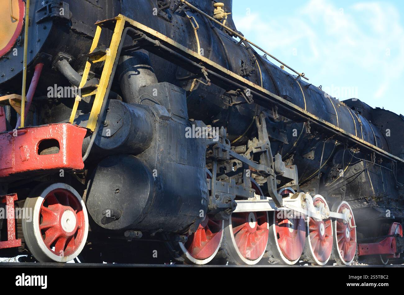 Antique black retro-train on track. A monument to the industrial ...