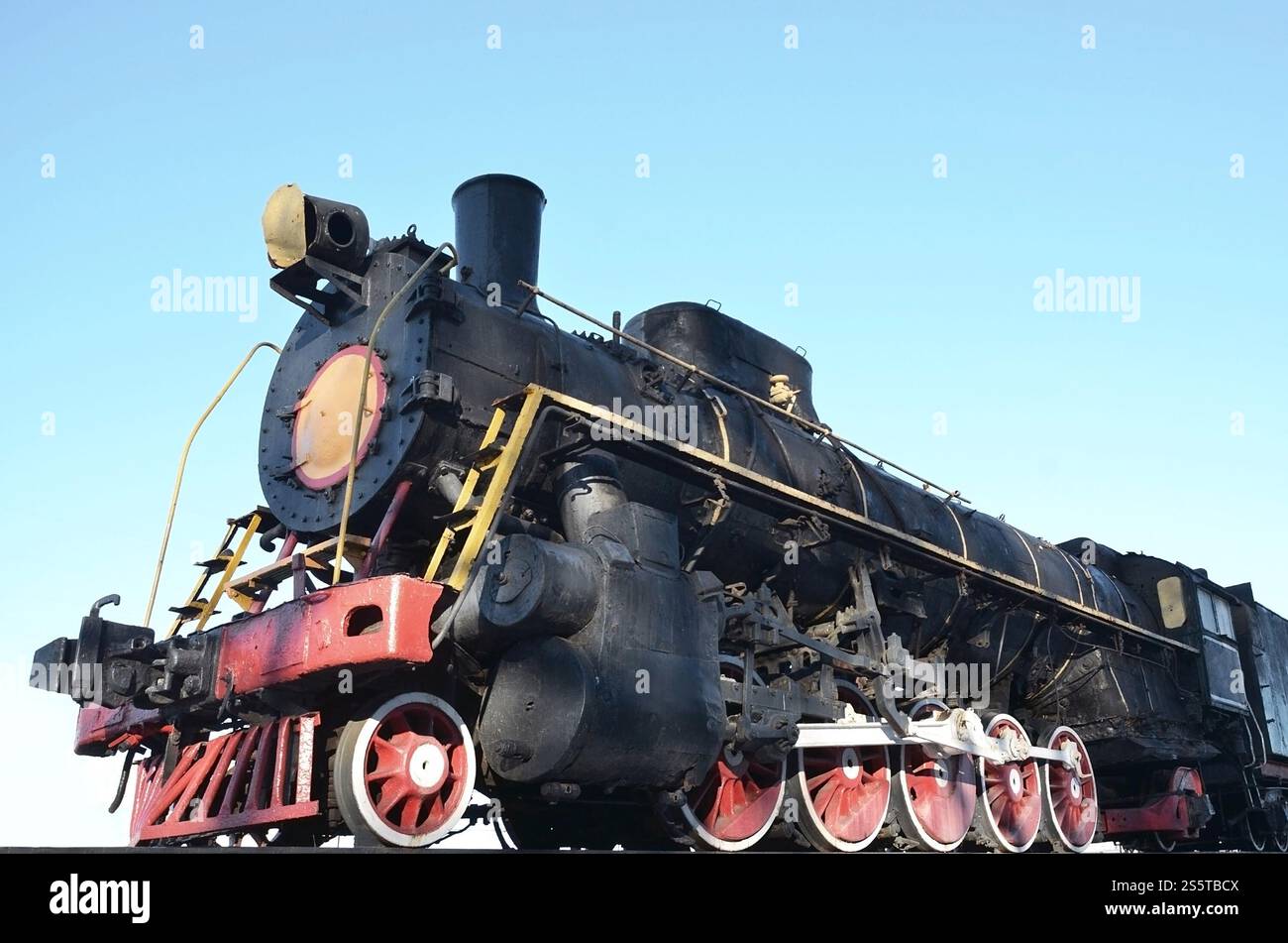 Antique black retro-train on track. A monument to the industrial ...
