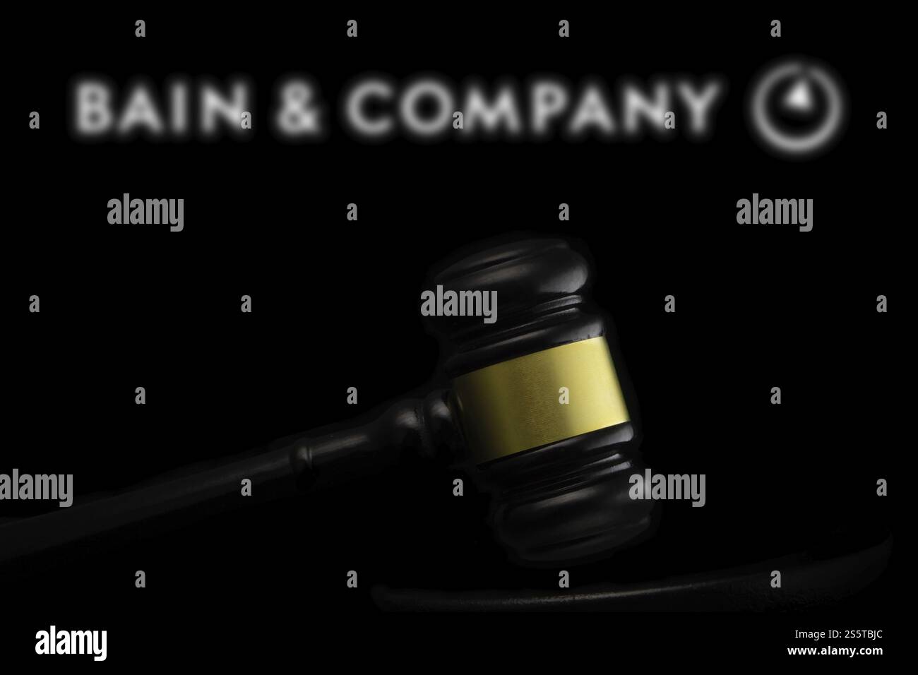Court gavel in front of the Bain & Company logo. Bain & Company is an ...