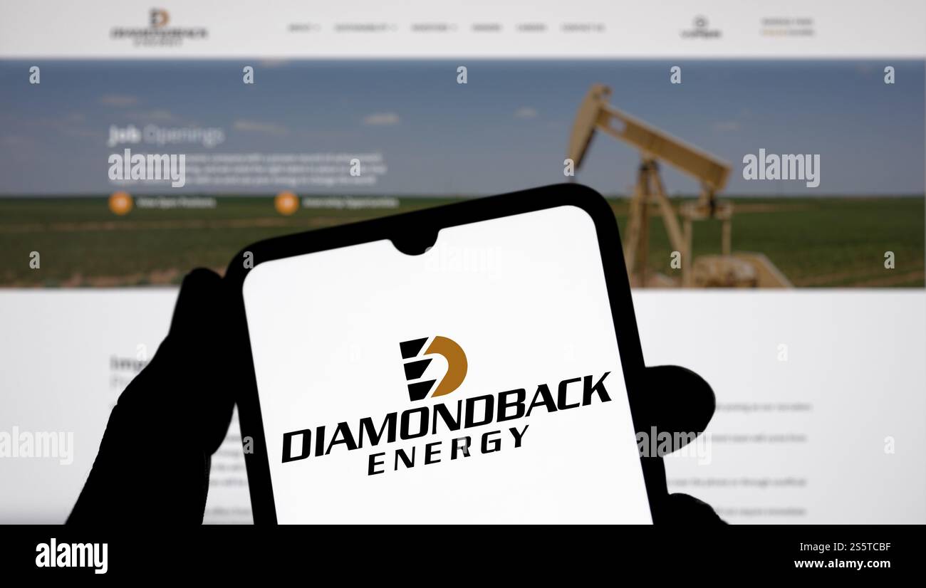 Diamond back energy logo is displayed on smartphone. Diamondback Energy ...