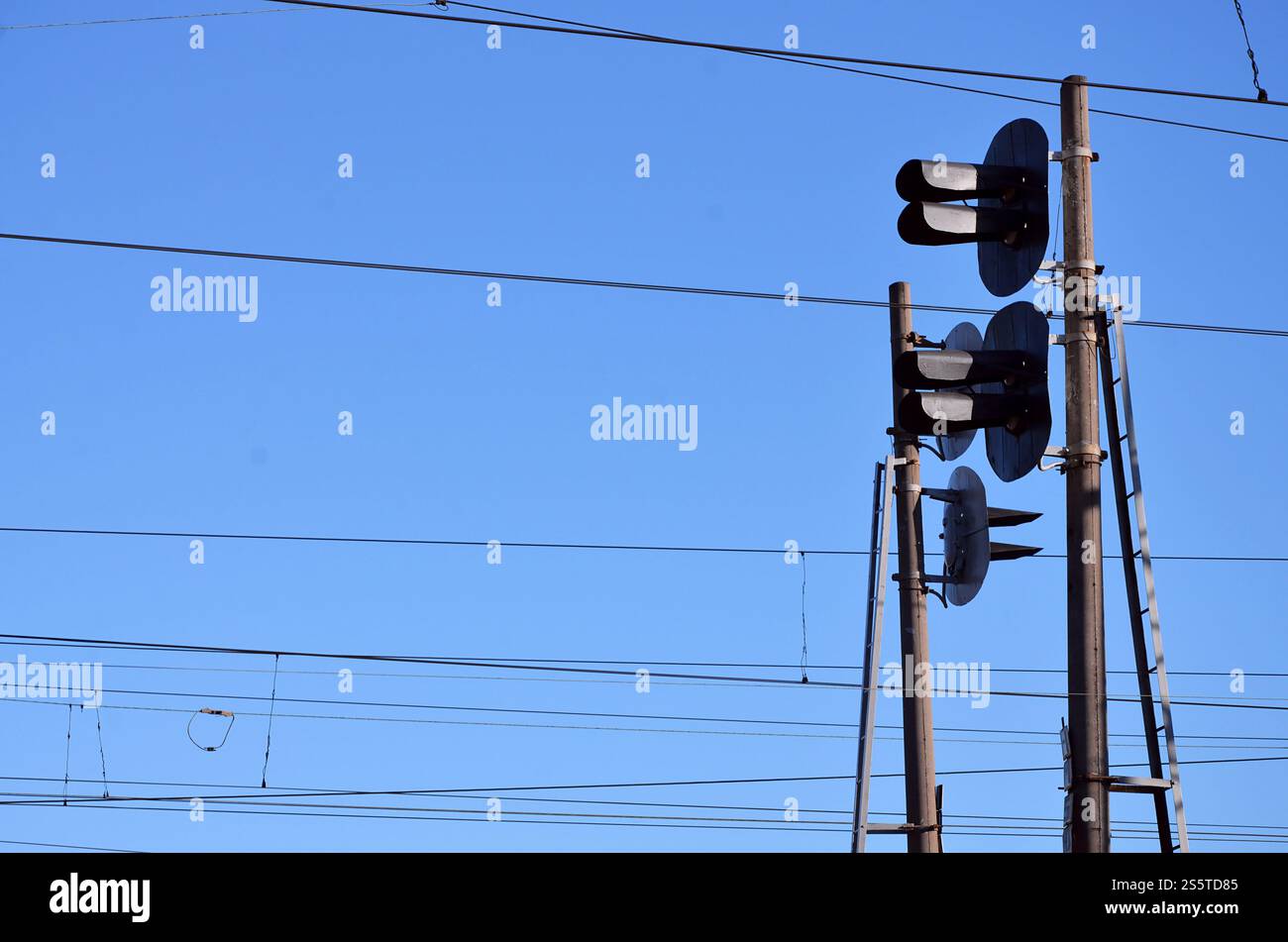 Railroad traffic light against clear blue sky, Contact wire. High ...