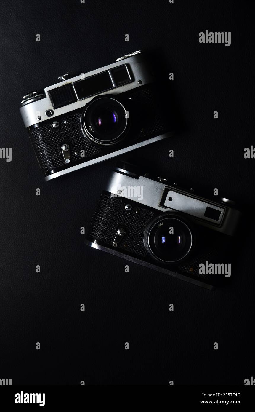 An old photo cameras from mid of 20th century on black leather ...