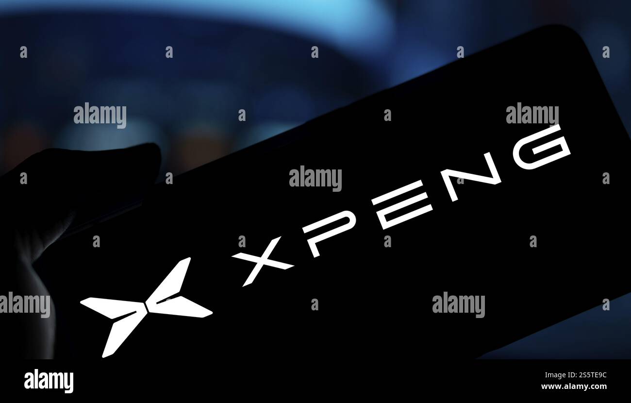 Xpeng logo is displayed on smartphone. Guangzhou Xiaopeng Motors ...