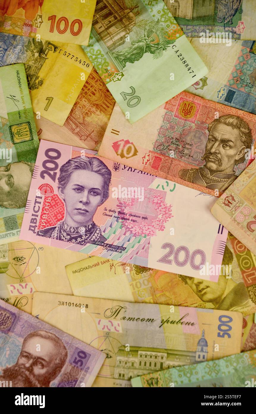 The background image of a pile of Ukrainian banknotes of different ...