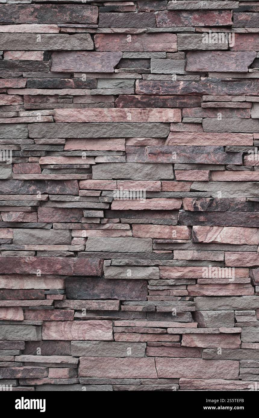 Texture of a stone wall from long and rough stones of different sizes ...