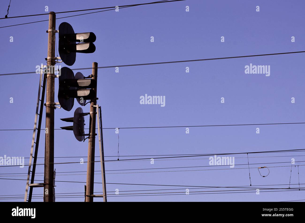 Railroad traffic light against clear blue sky, Contact wire. High ...