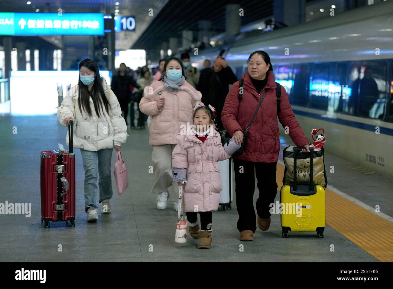 Chengdu,China.14th January 2025. Passengers with luggage walk on the ...