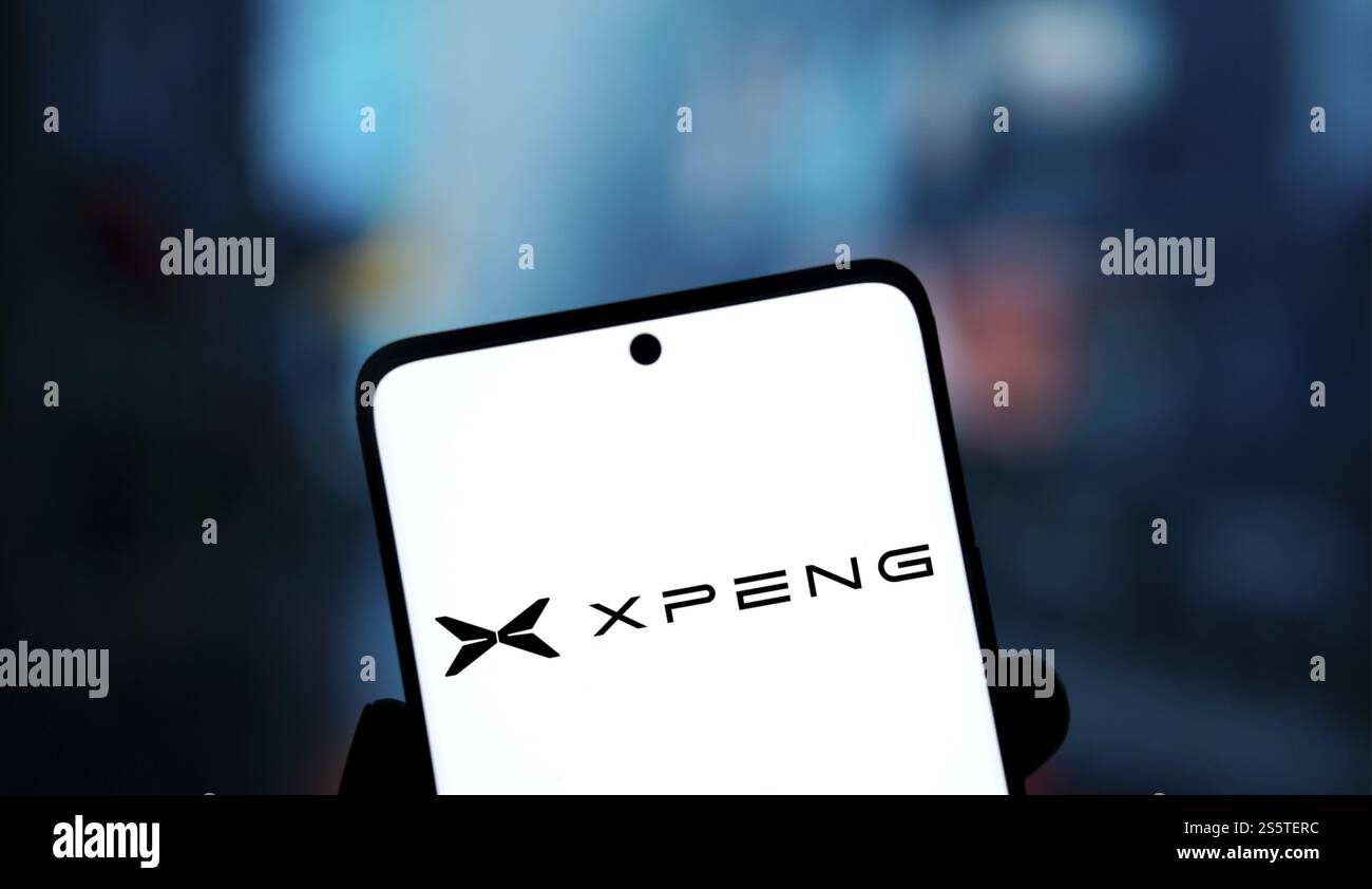 Xpeng logo is displayed on smartphone. Guangzhou Xiaopeng Motors ...