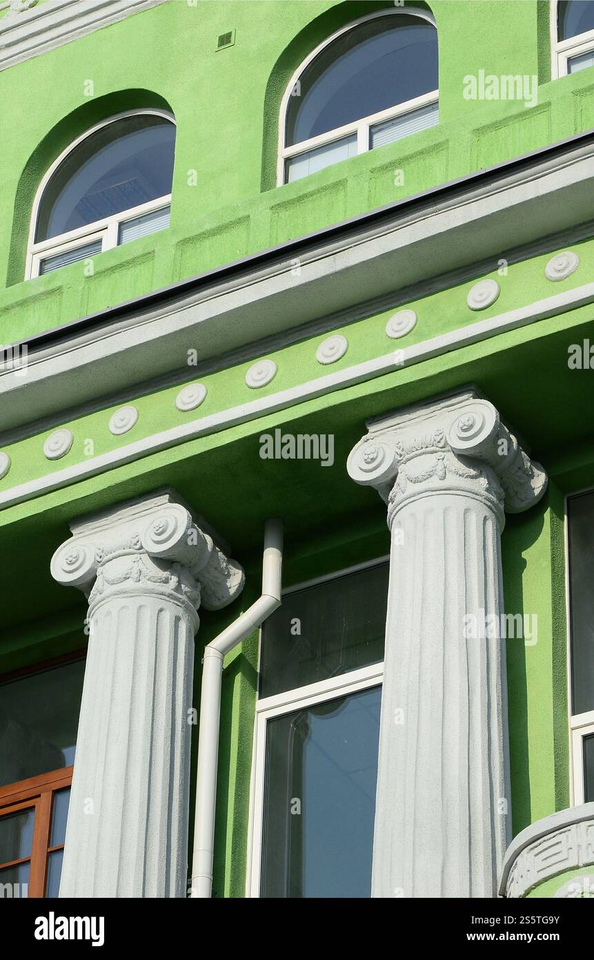 Restored old multi-storey building with antique columns, painted in ...