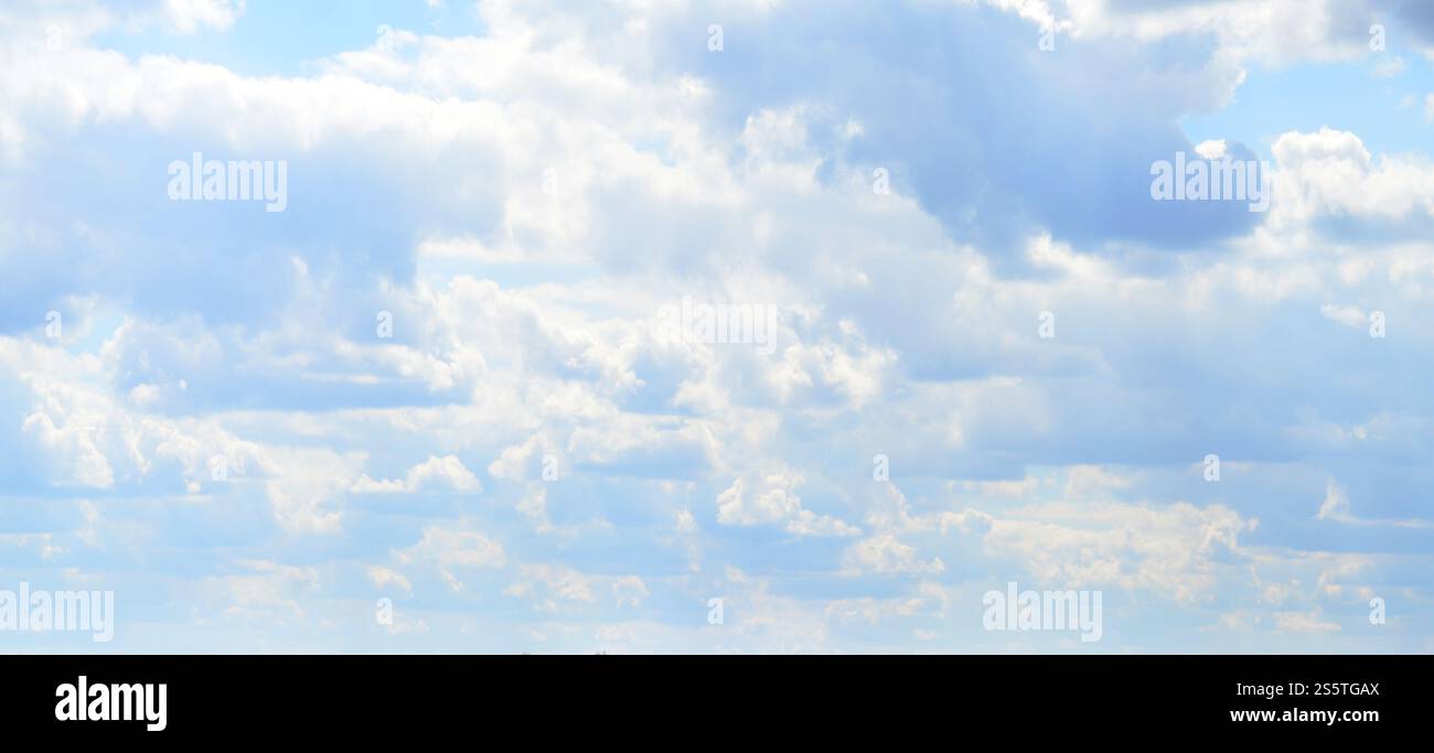 Heavenly space of blue color with a lot of thick white clouds ...