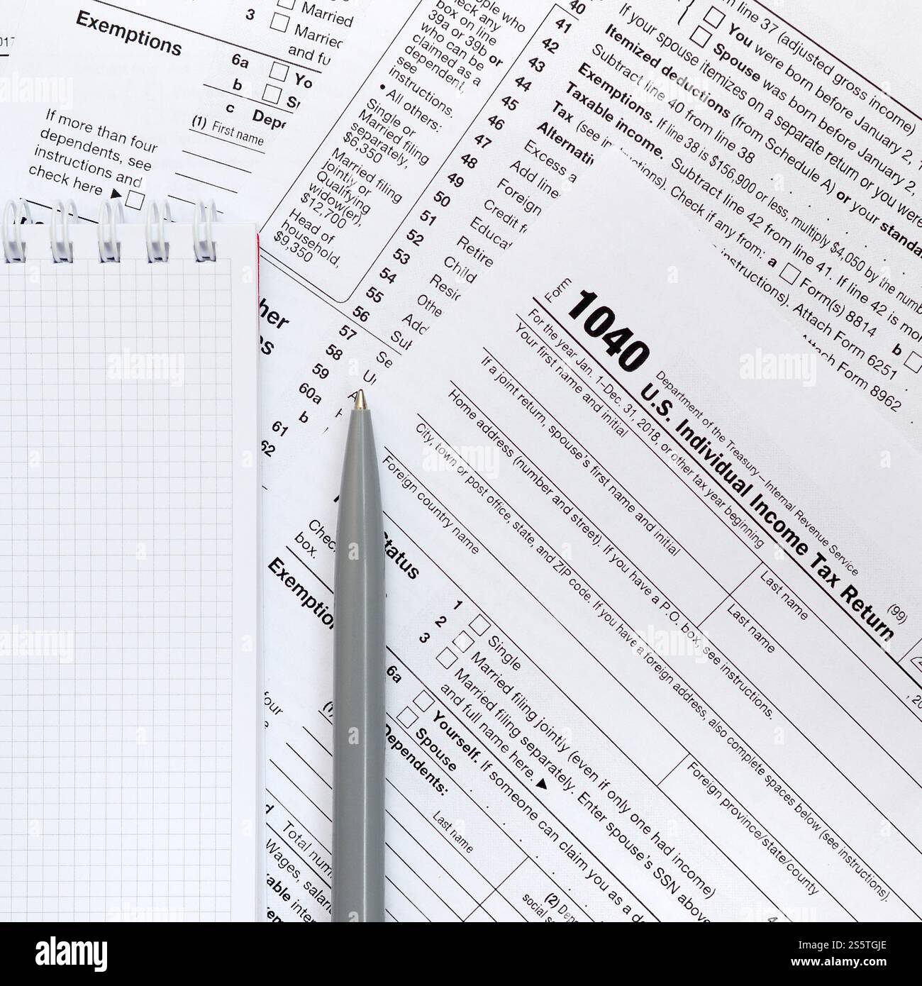 The pen and notebook is lies on the tax form 1040 U.S. Individual ...